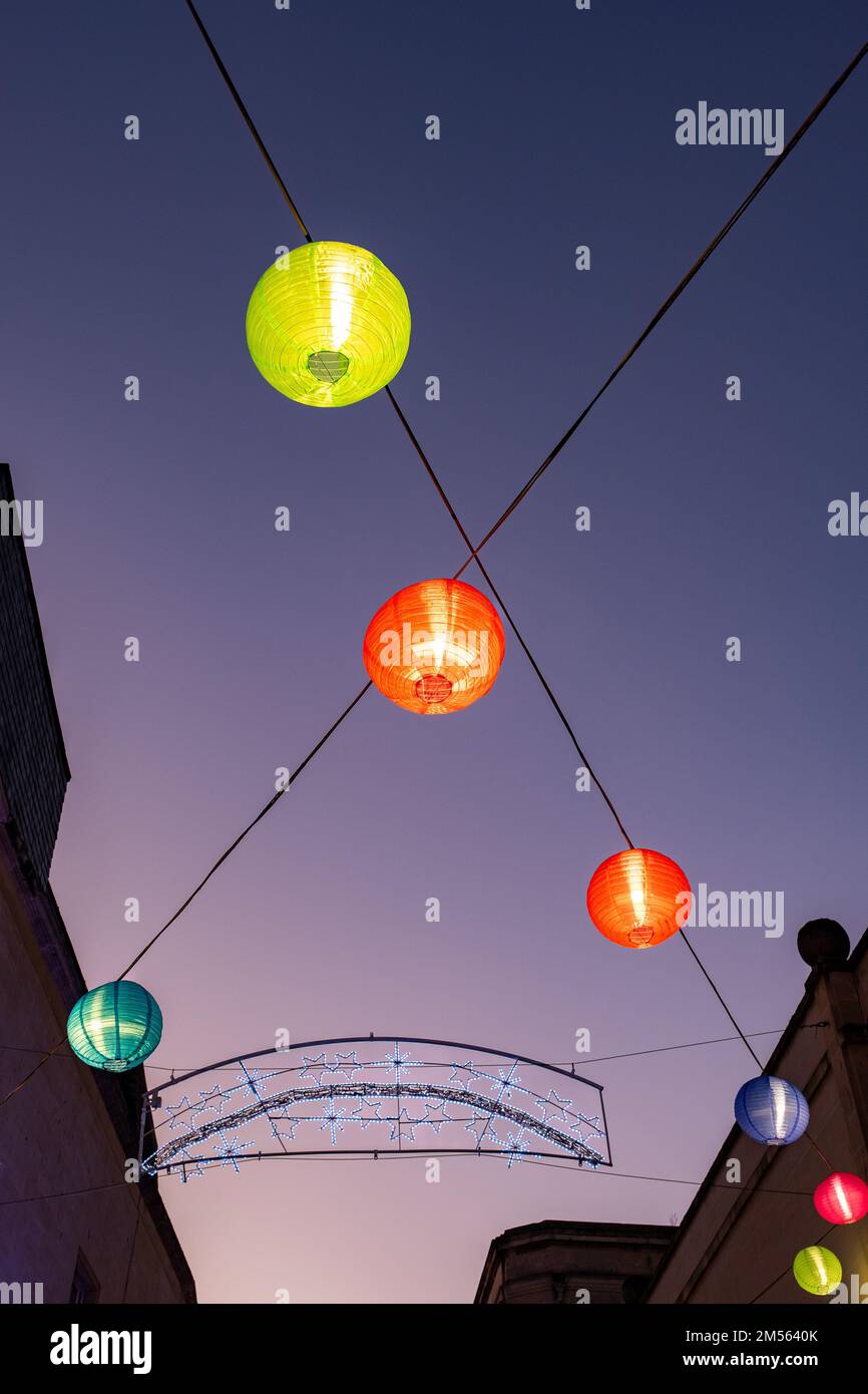 A vertical low-angle view of suspended Chinese Christmas lanterns at ...