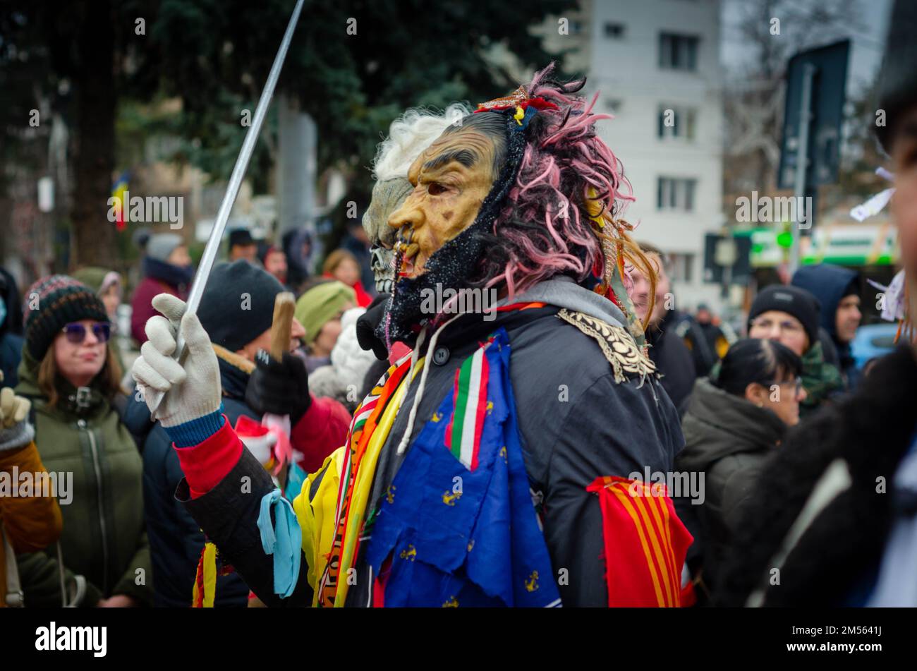 People wearing colorful costumes and masks perform during a traditional ...