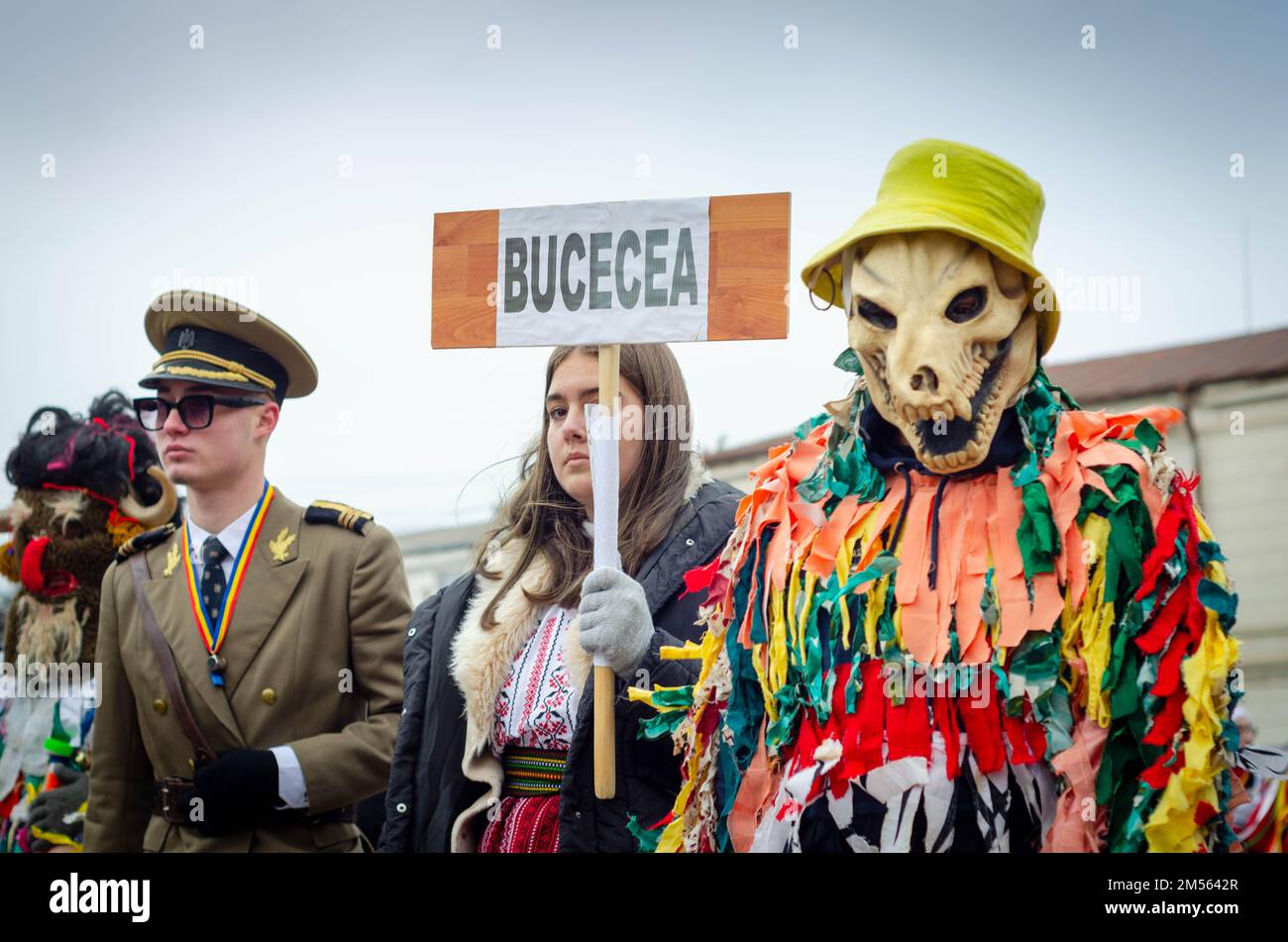 People wearing colorful costumes and masks perform during a traditional ...