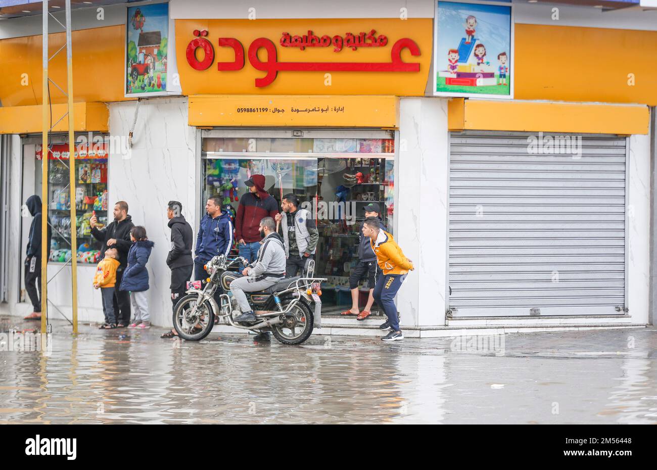 Gaza, Palestine. 26th Dec, 2022. Palestinians stand next to their shops ...