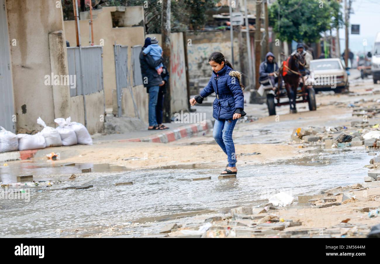 Gaza, Palestine. 26th Dec, 2022. A Palestinian girl walks through a ...