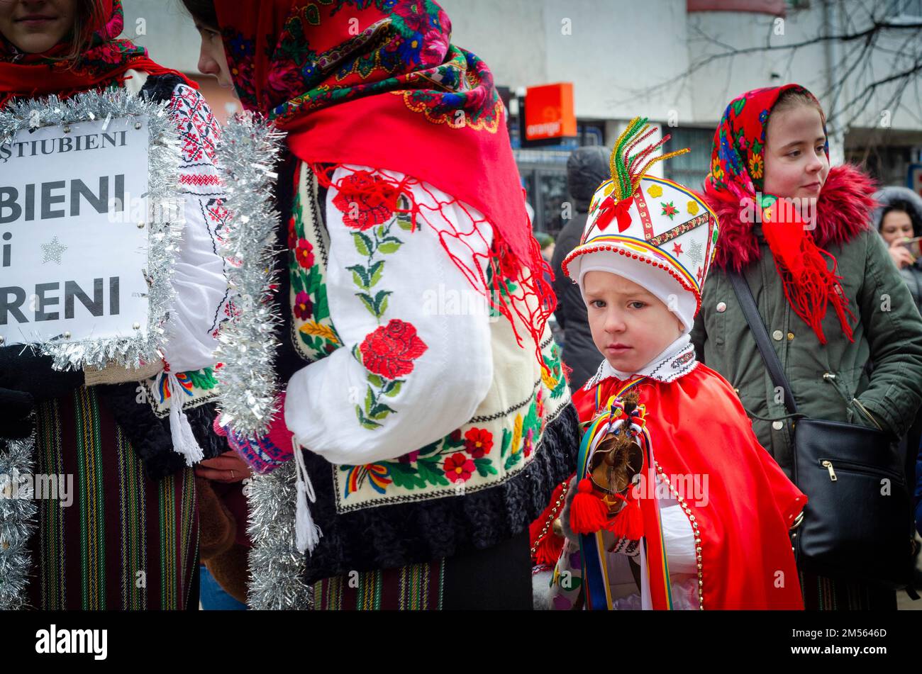 People wearing colorful costumes and masks perform during a traditional ...