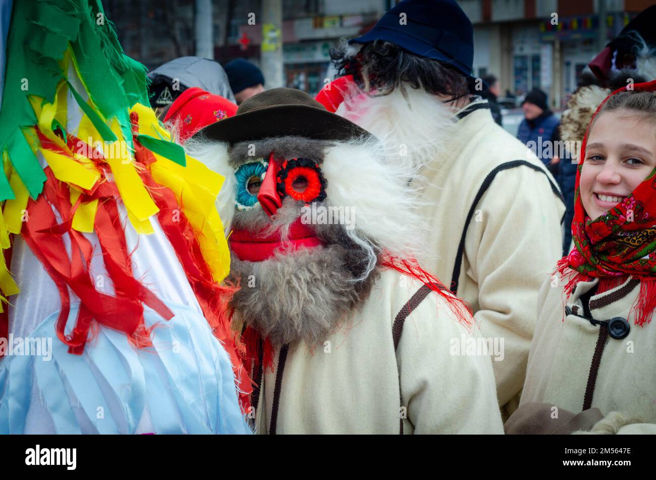 People wearing colorful costumes and masks perform during a traditional ...