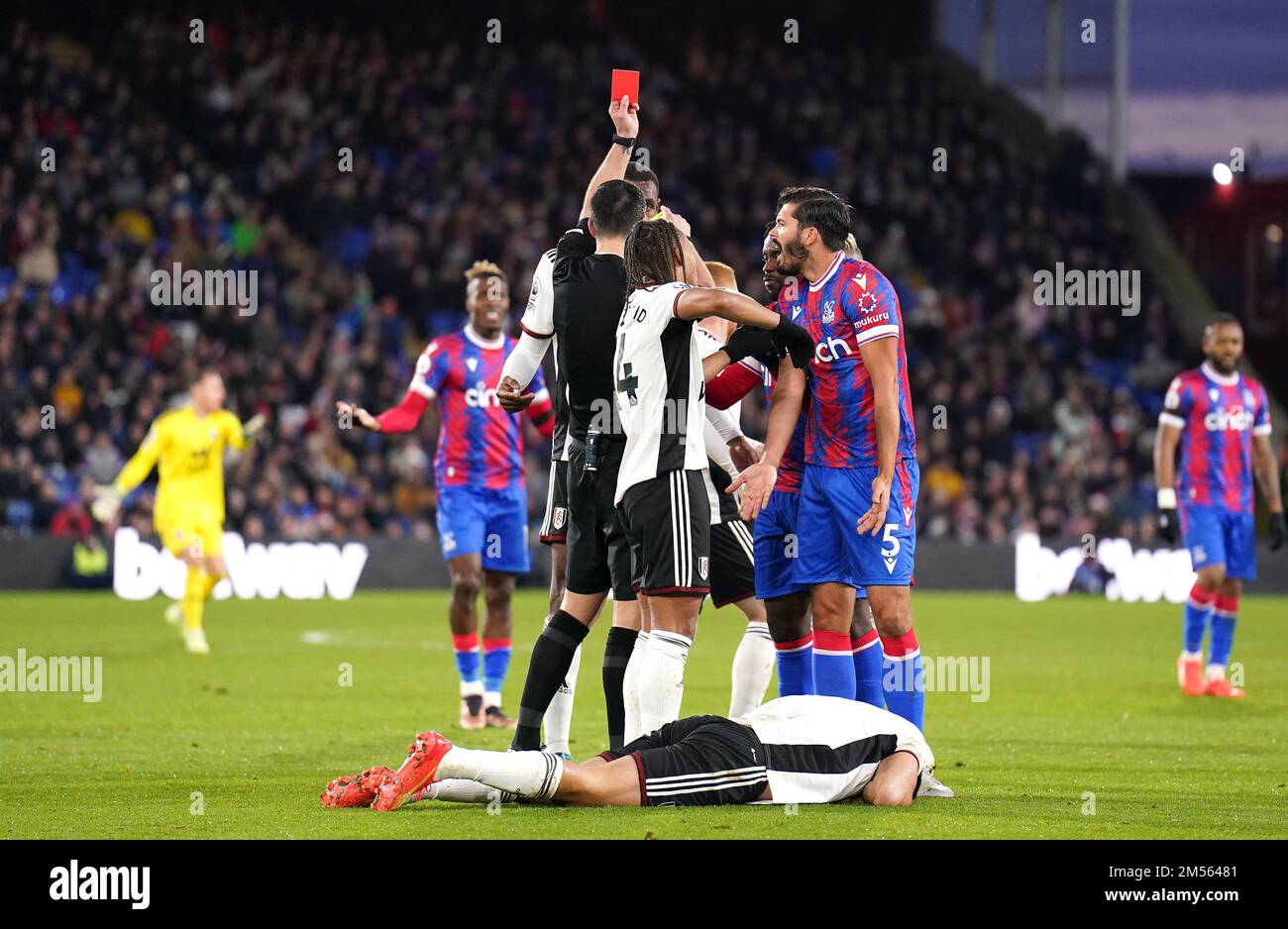 Referee Andrew Madley shows a red card to Crystal Palace's James ...