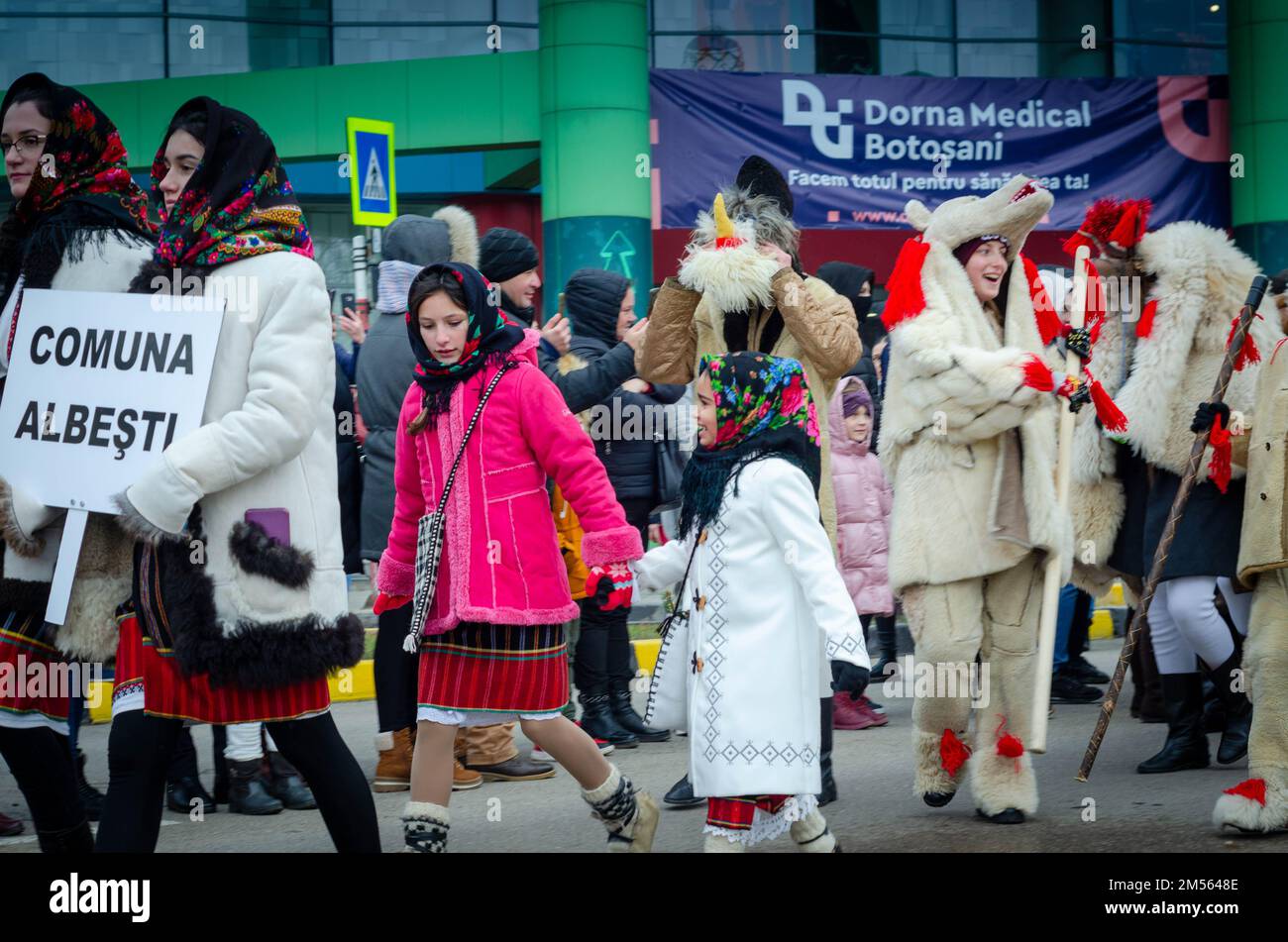 People wearing colorful costumes and masks perform during a traditional ...
