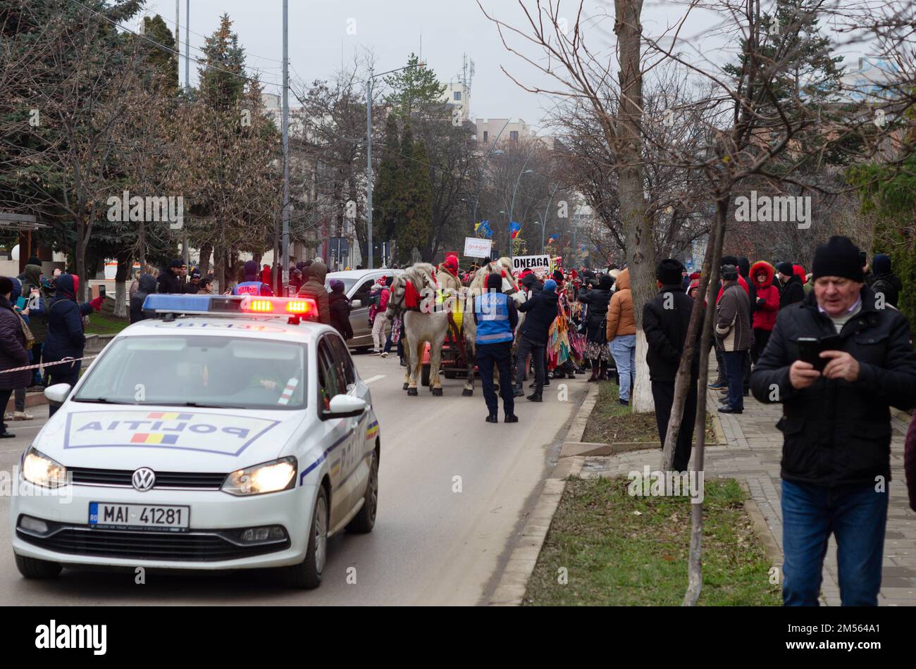 People wearing colorful costumes and masks perform during a traditional ...