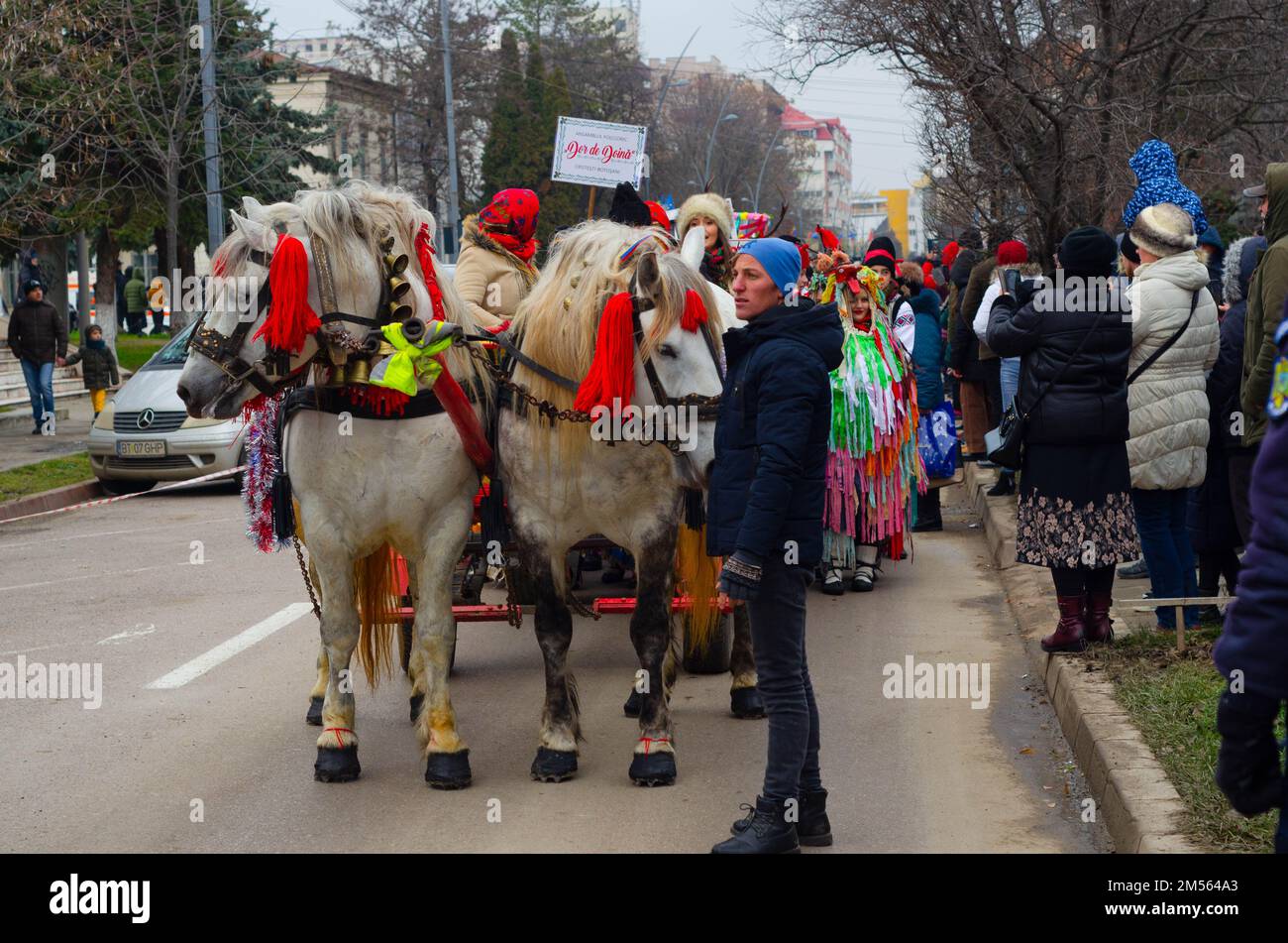 People wearing colorful costumes and masks perform during a traditional ...
