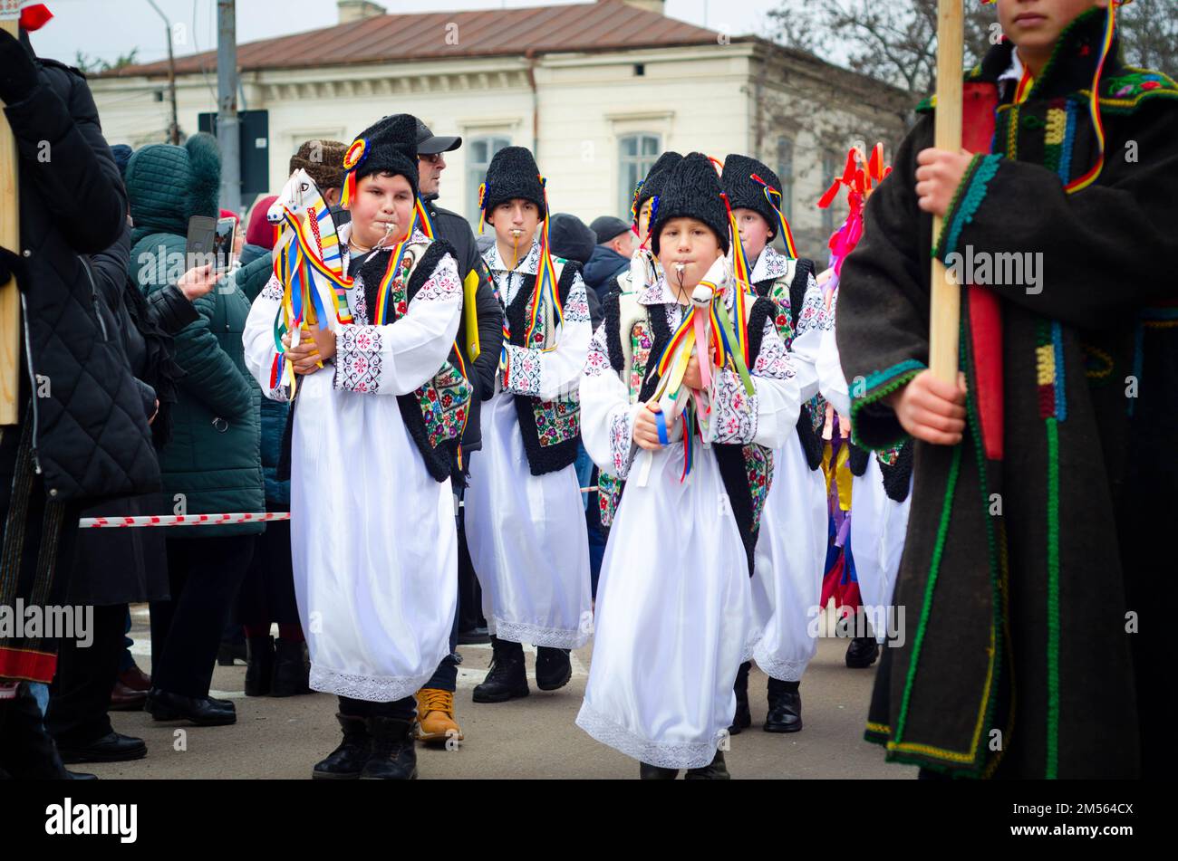 People wearing colorful costumes and masks perform during a traditional ...
