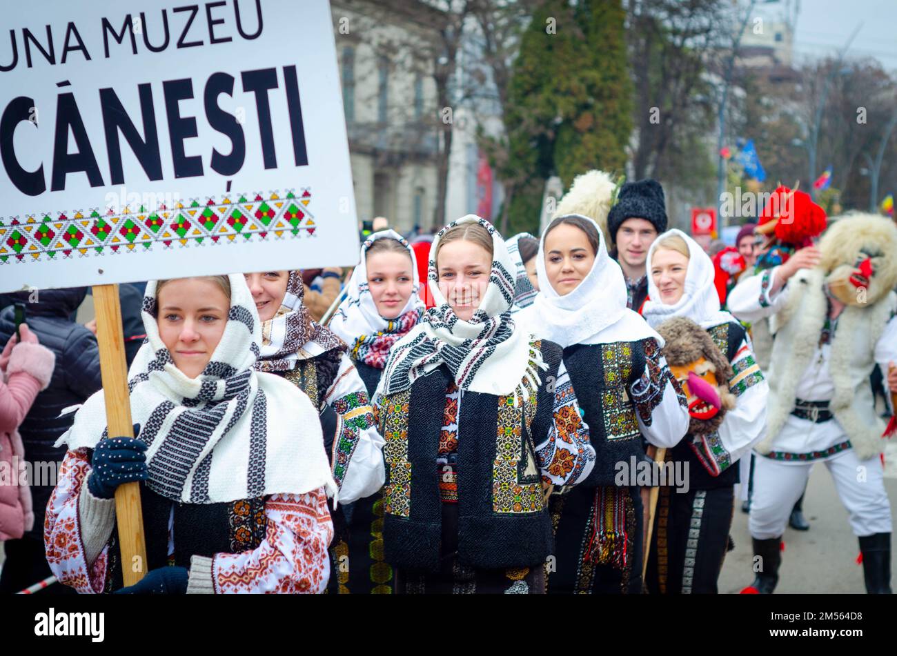 People wearing colorful costumes and masks perform during a traditional ...