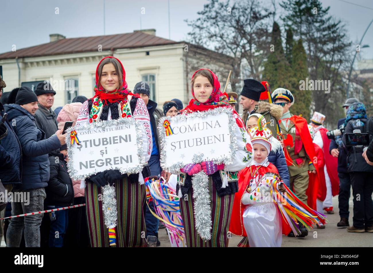 People wearing colorful costumes and masks perform during a traditional ...