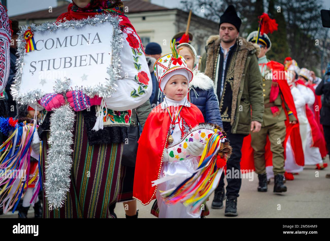 People wearing colorful costumes and masks perform during a traditional ...