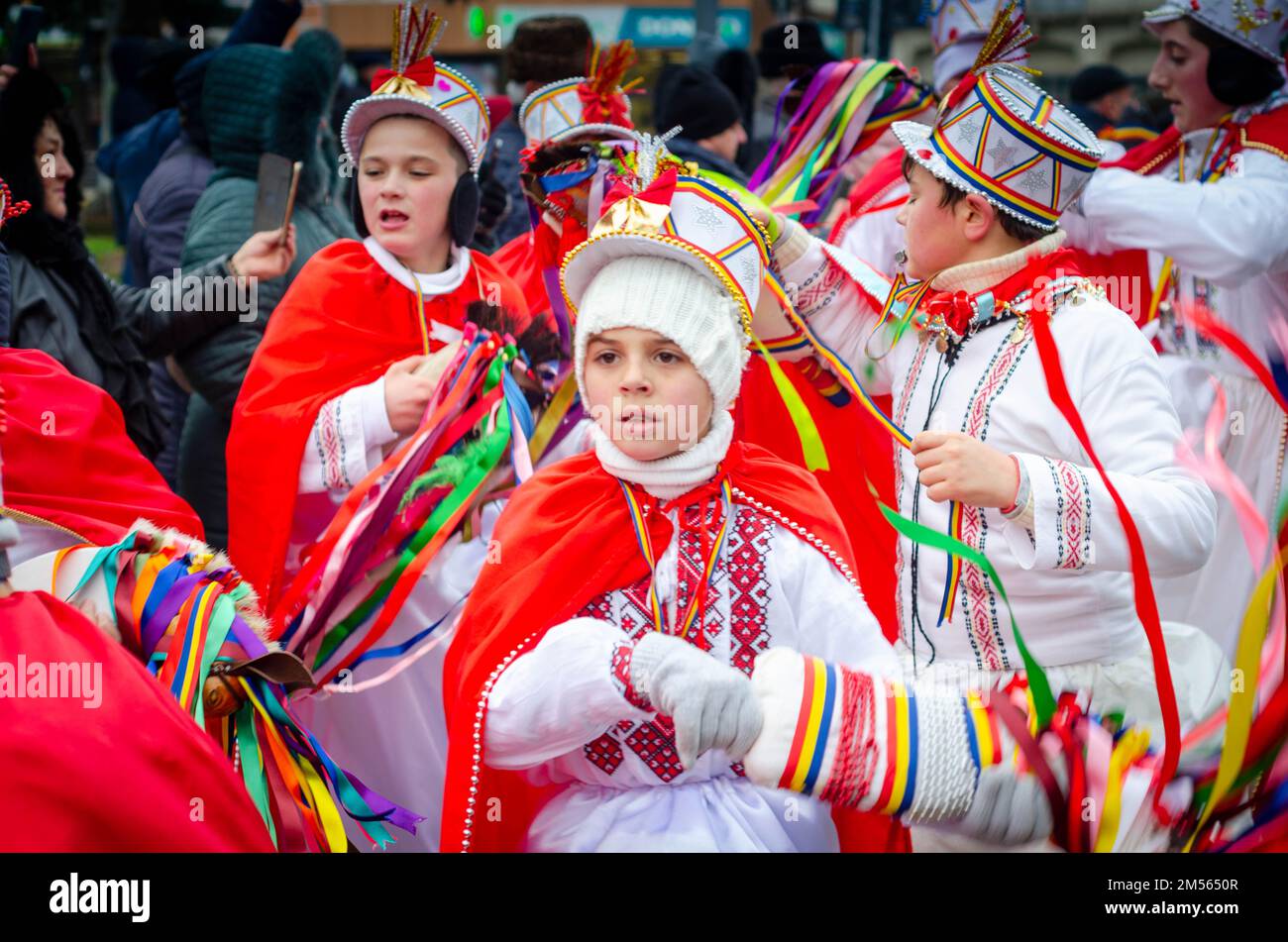 People wearing colorful costumes and masks perform during a traditional ...