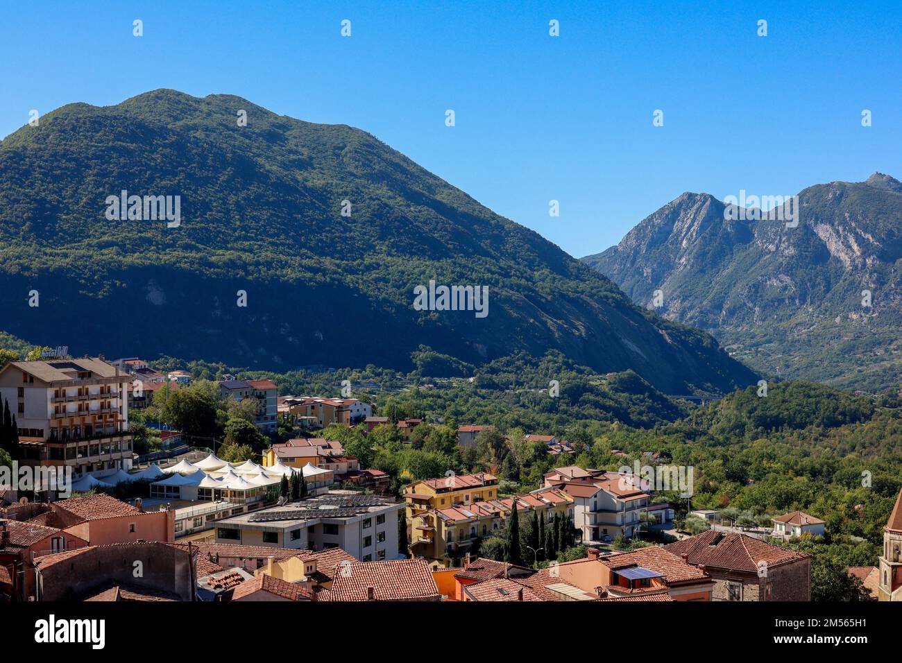 A beautiful cityscape of Lauria laying at the foot of green mountains ...