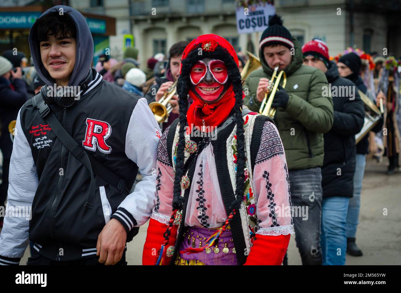 People wearing colorful costumes and masks perform during a traditional ...