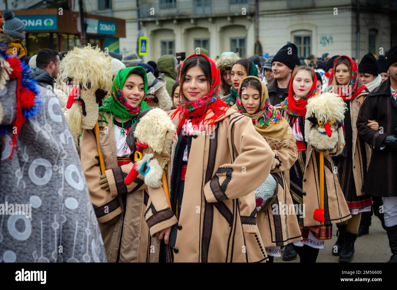 People wearing colorful costumes and masks perform during a traditional ...