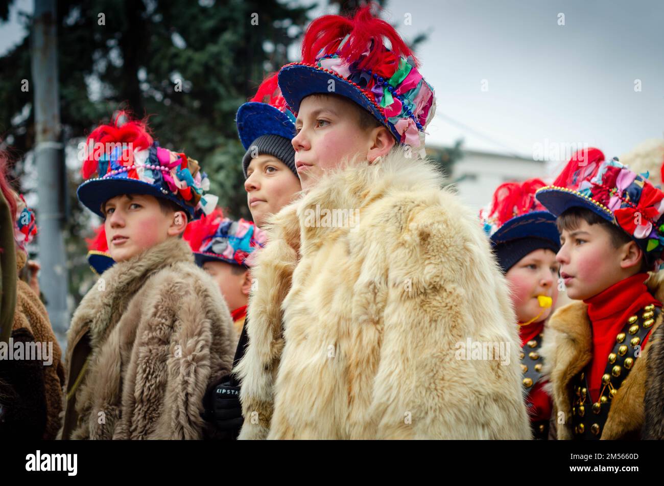 People wearing colorful costumes and masks perform during a traditional ...