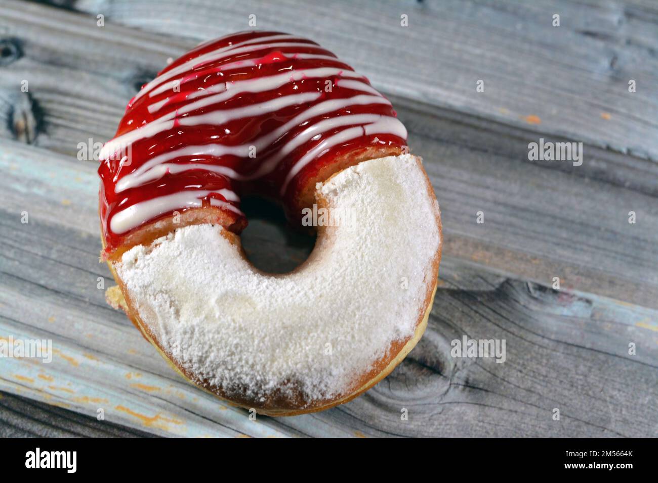Icing powdered confectioners' sugar and Strawberry flavored ring donut ...