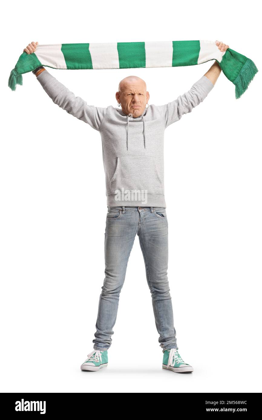 Full length portrait of a man cheering with a green and white scarf ...