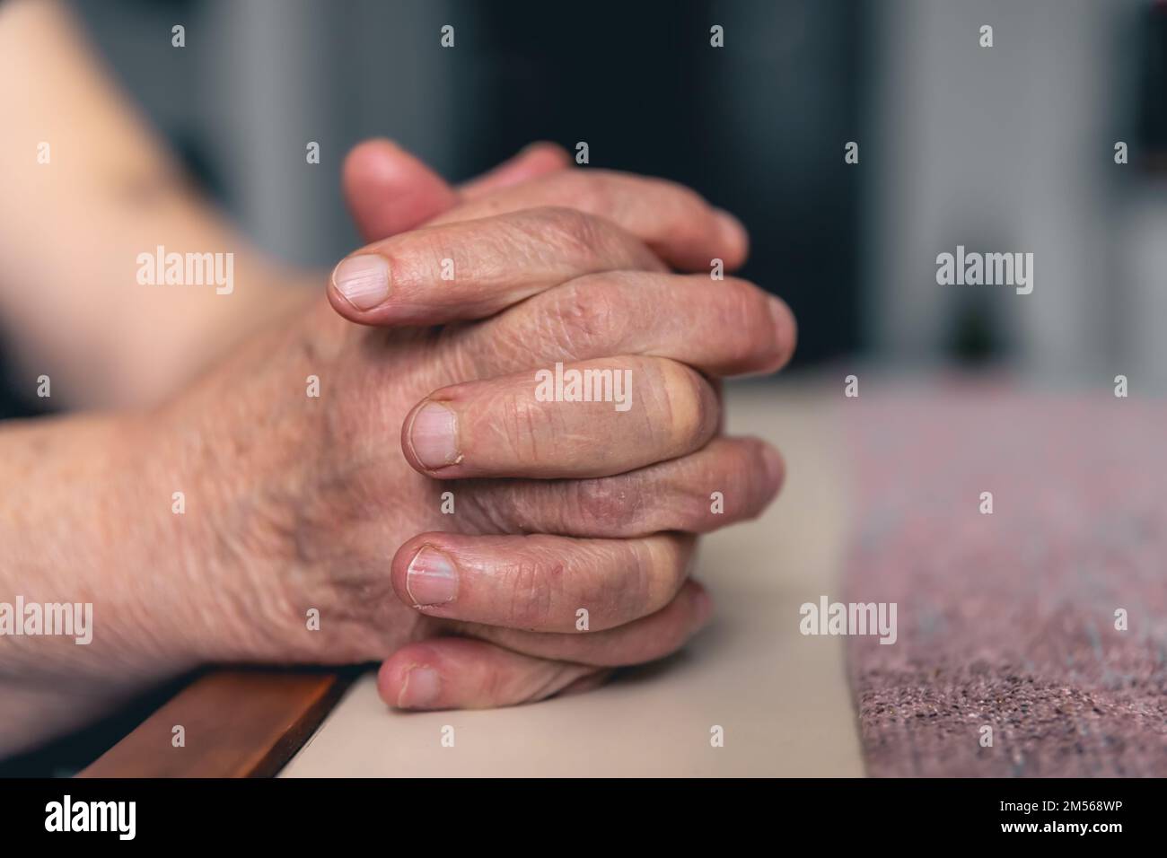 Elderly women with folded hands hi-res stock photography and images - Alamy