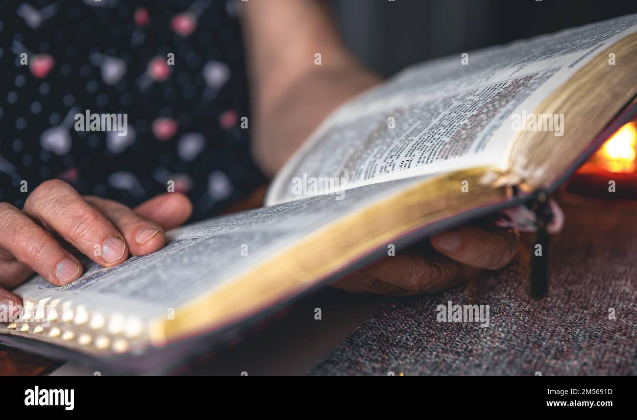 An old woman reads the Bible, hands close up Stock Photo - Alamy