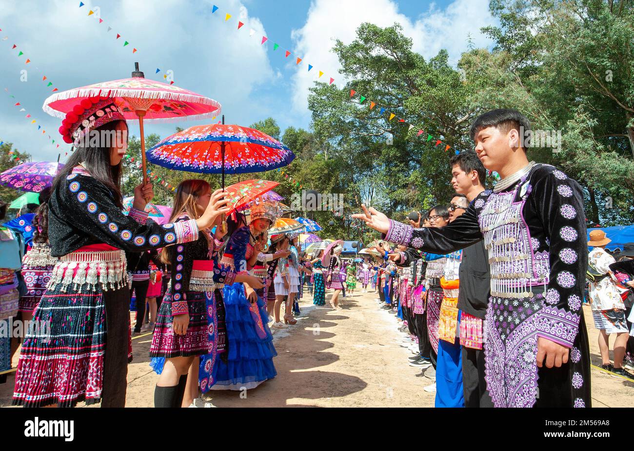 Hmong hill tribe men and women wear colorful interpretations of ...