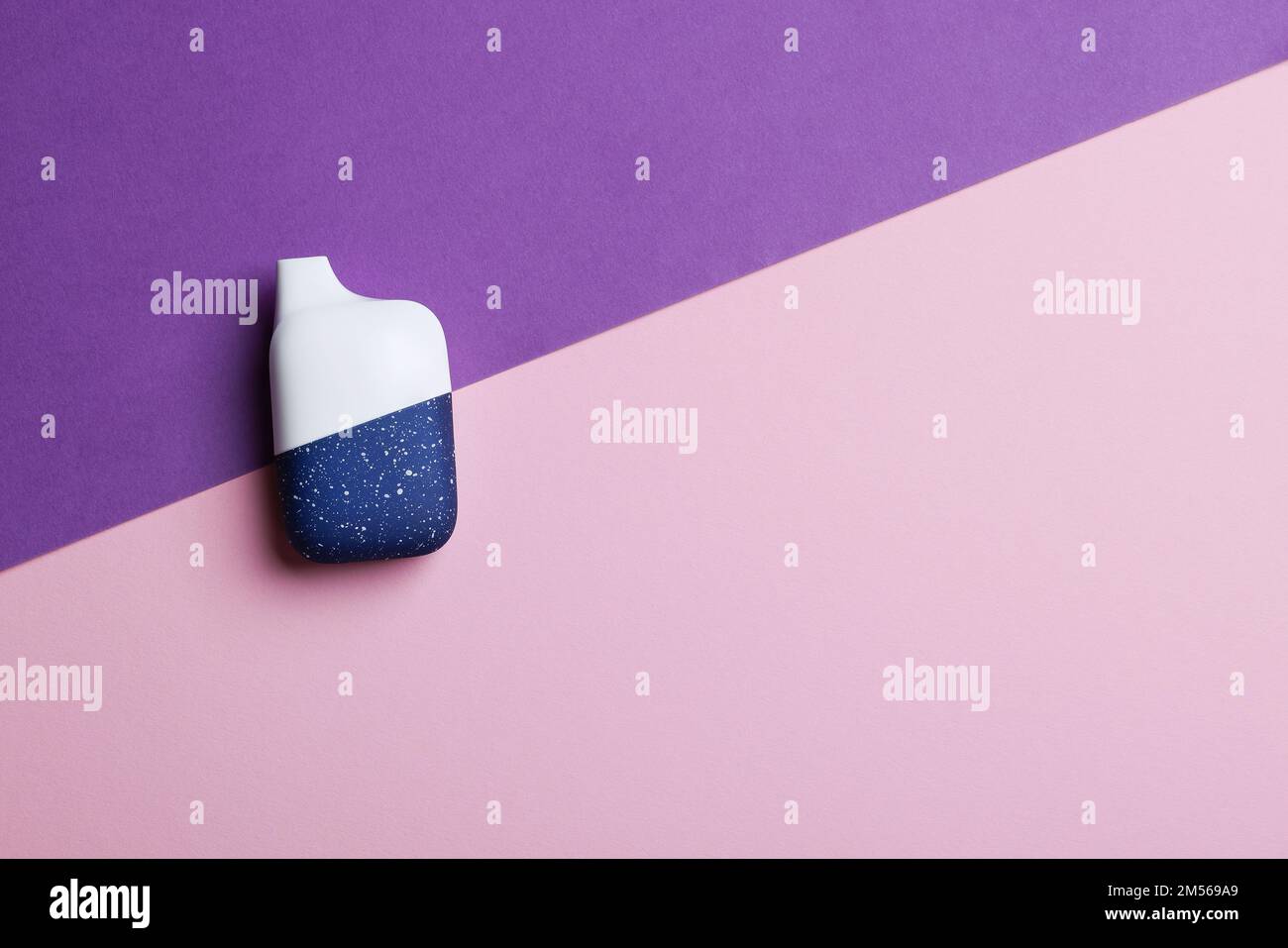 disposable electronic cigarette or vape on purple background. top view ...