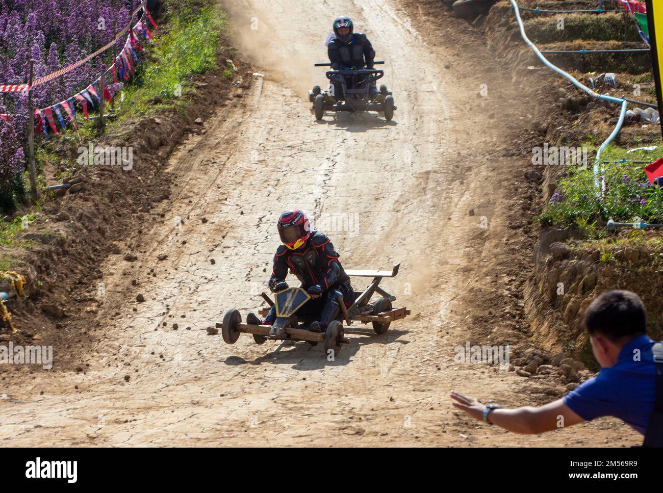 Hmong hill tribe men drive formula hmong (the wooden cart racing the ...
