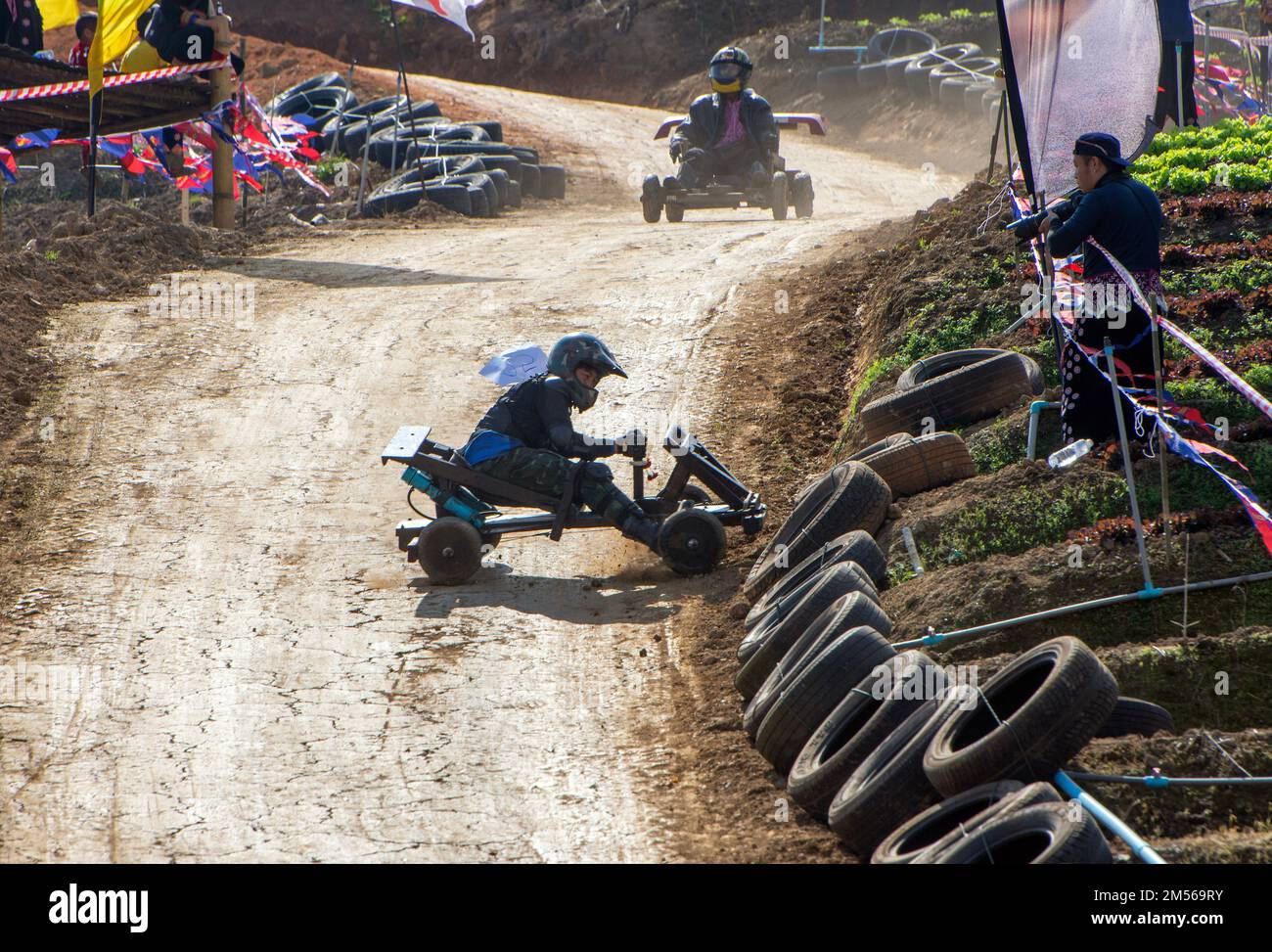 Hmong hill tribe men drive formula hmong (the wooden cart racing the ...