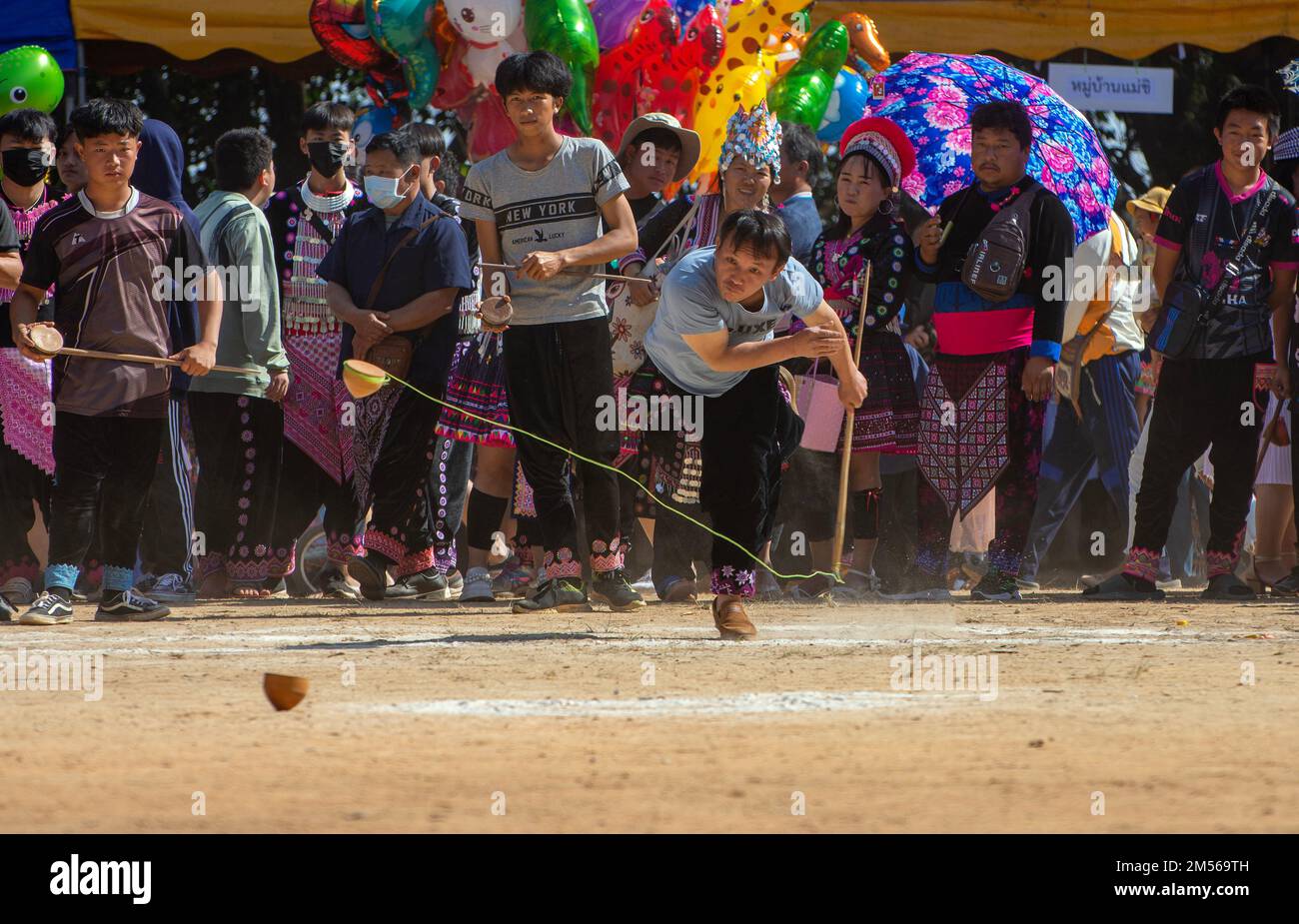 A Hmong hill tribe man playing top spinning competition (traditional ...