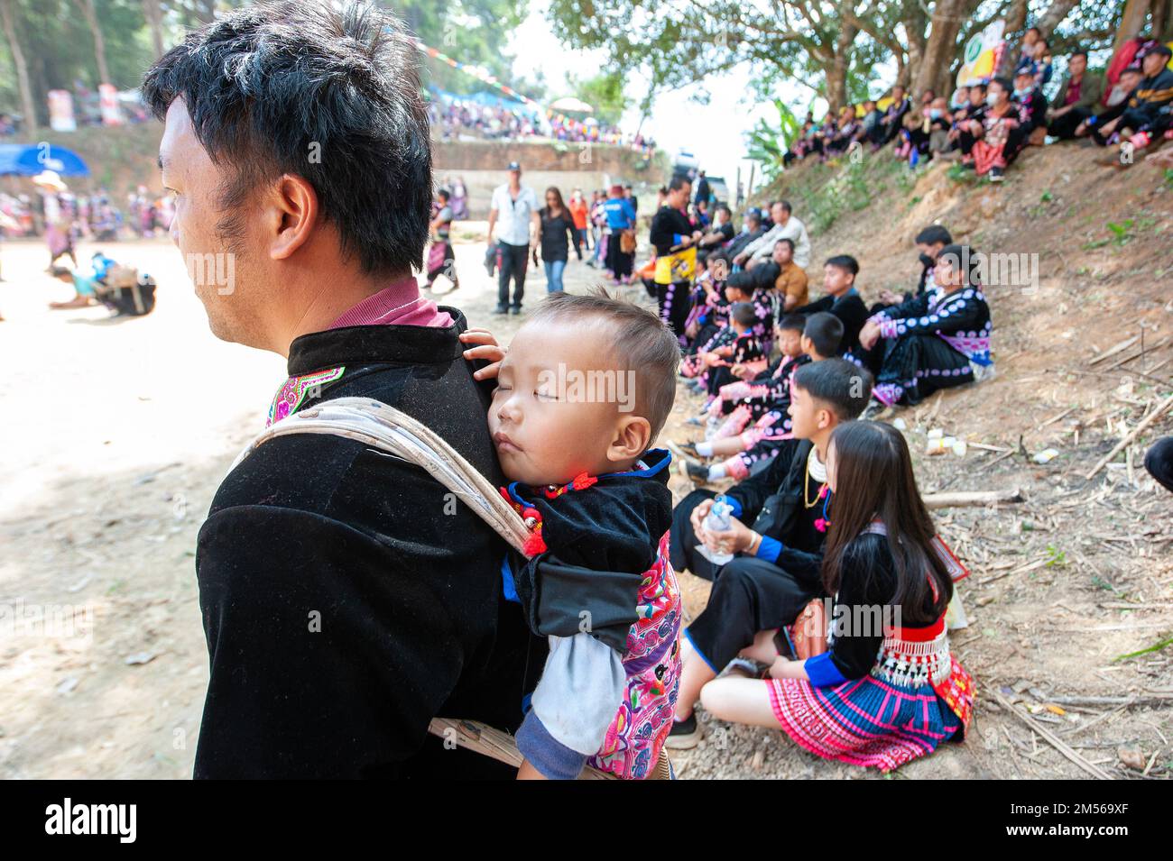 Hmong hill tribe man carries his sleeping baby during the Hmong New ...