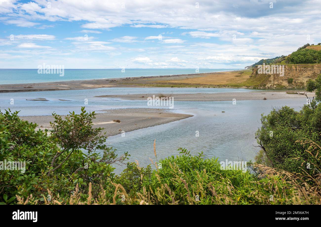 The pebbles on Hurunui River Mouth under blue cloudy sky in South ...