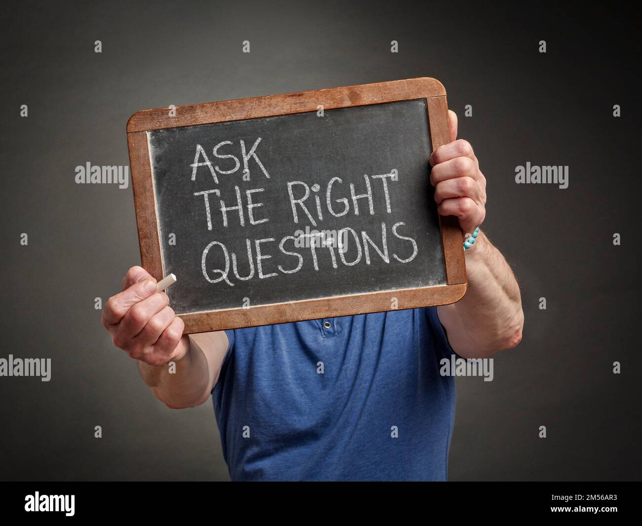 ask the right questions - white chalk text on a slate blackboard held ...