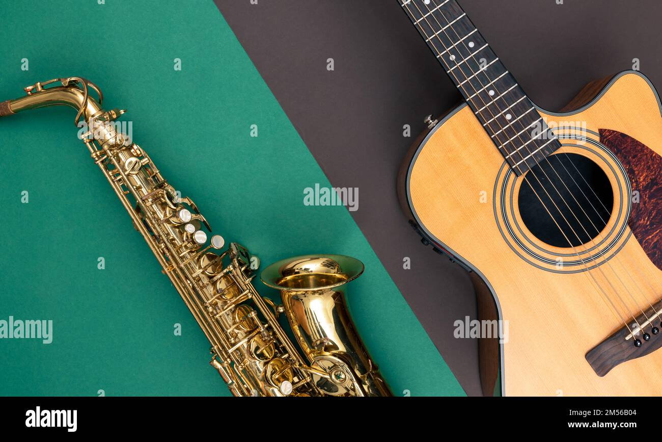 Guitar and saxophone on paper background, top view Stock Photo - Alamy