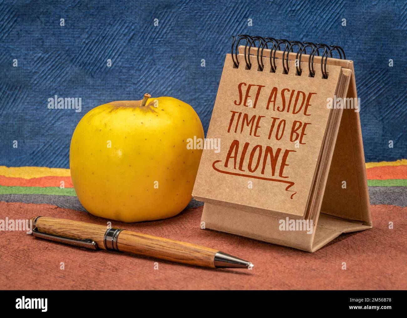 set aside time to be alone - a note in a small desktop calendar, self ...