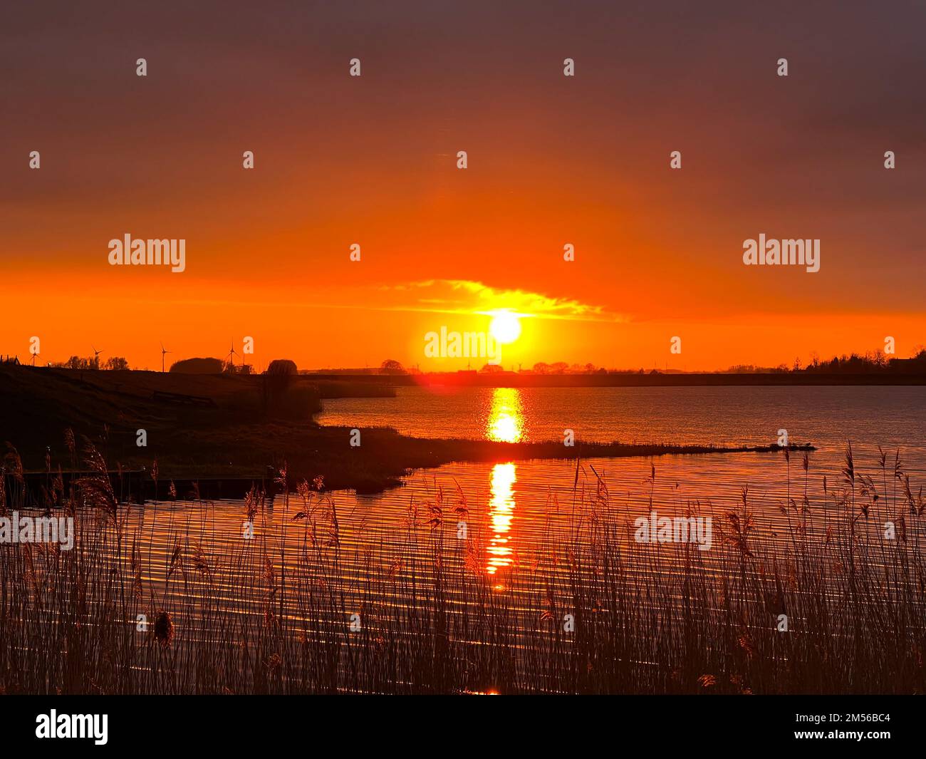A scenic sunset over a lake in North Holland Stock Photo - Alamy