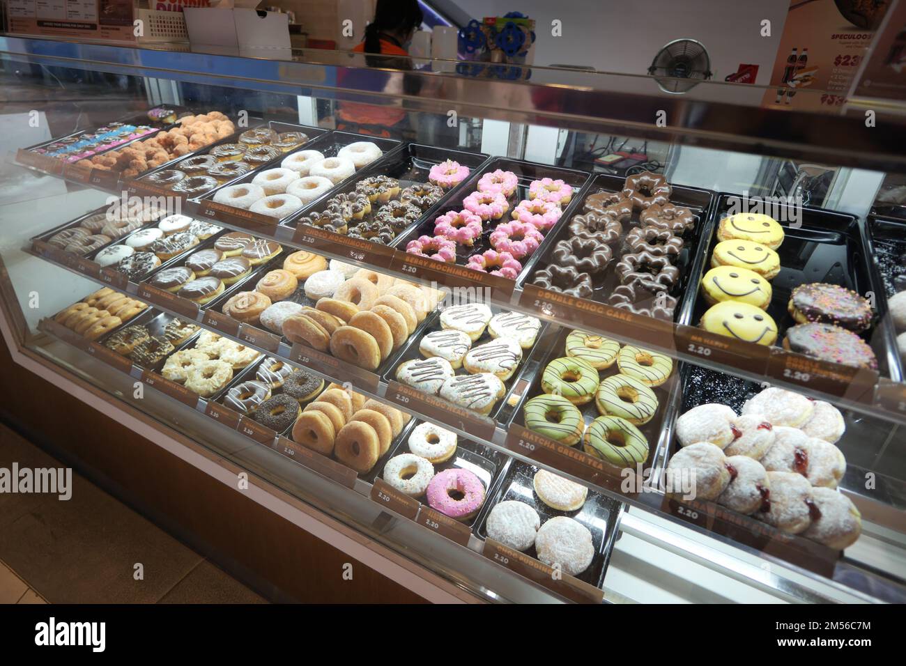 chocolate donuts display for sale at local store Stock Photo - Alamy