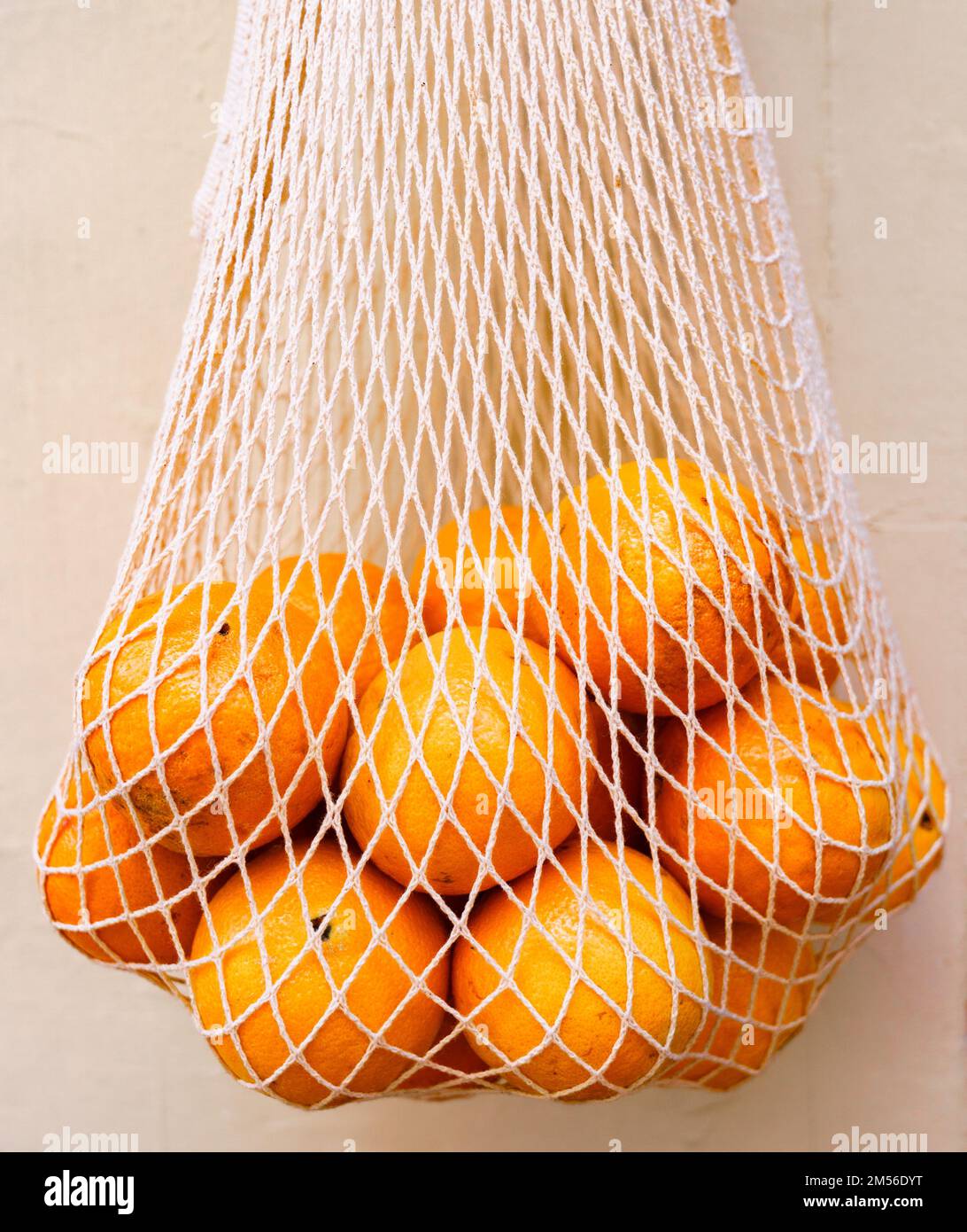 Net full with fresh orange fruits Stock Photo - Alamy