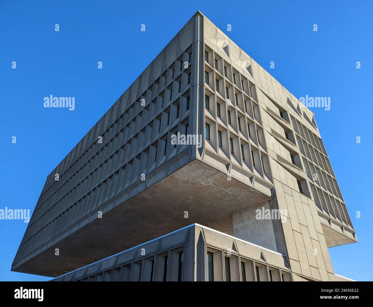 A low angle of the Marcel Breuer Building with blue sky background in ...