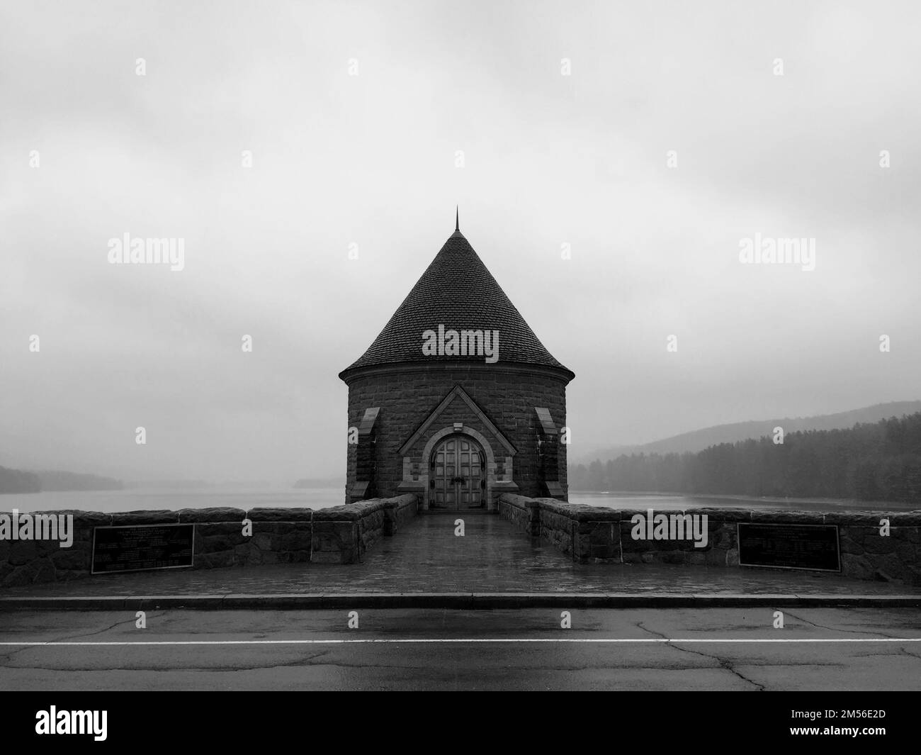 A grayscale of the Saville Dam in Barkhamsted, Connecticut on a gloomy ...