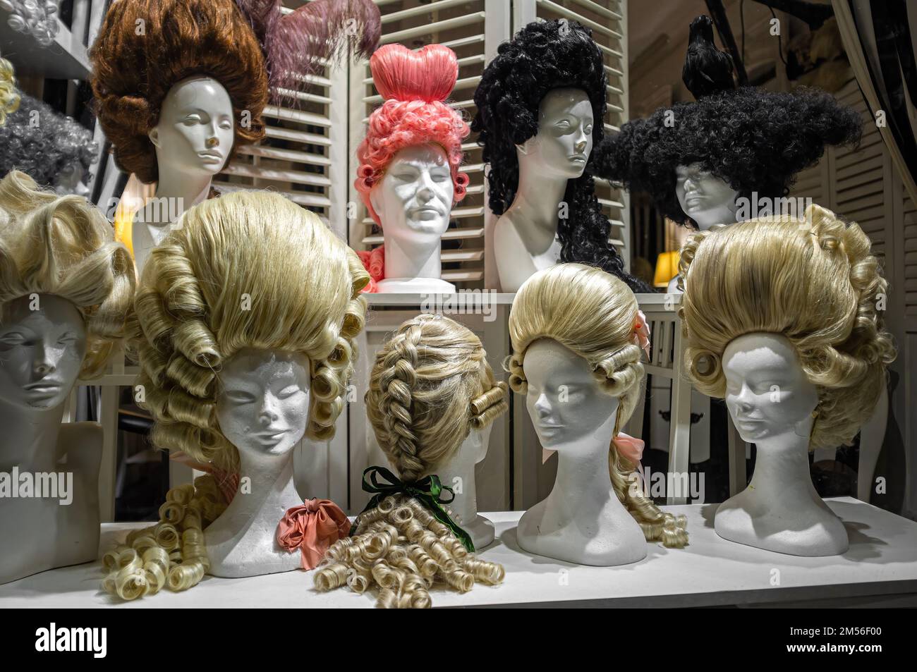 Female mannequin heads with wigs, behind a wig shop window Stock Photo ...