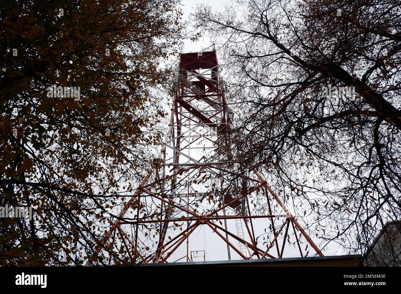 An old television and radio tower in faded colors looks vertically at ...