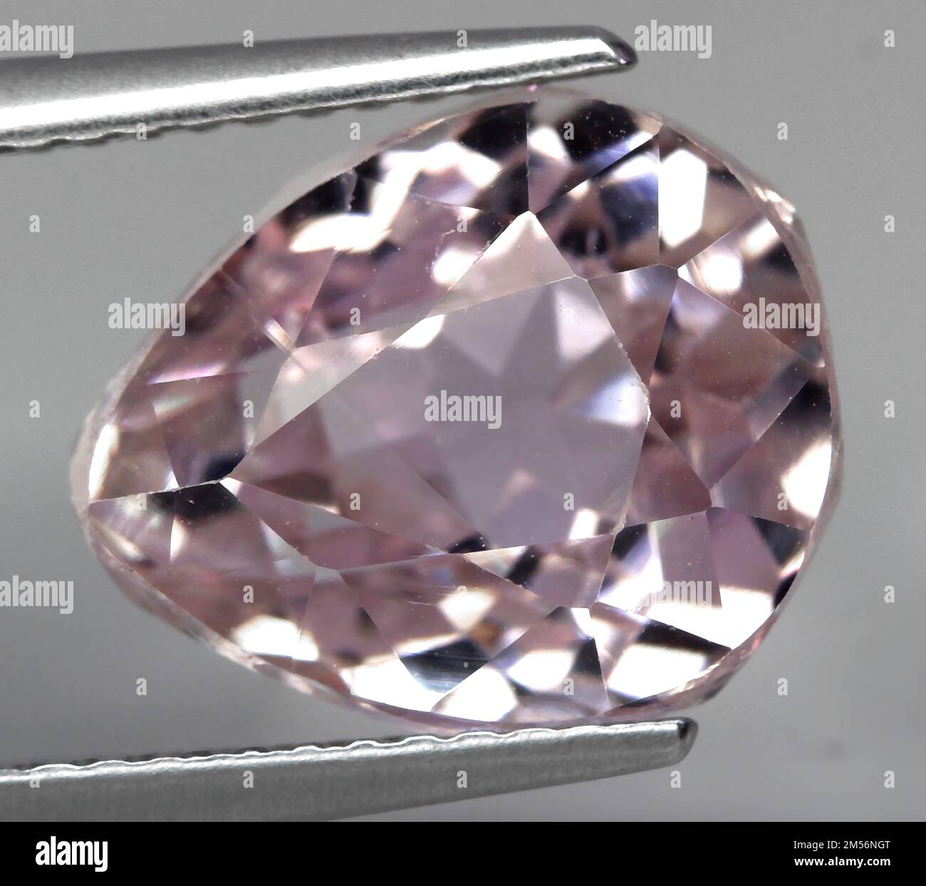 Natural beautiful stone kunzite on gray background Stock Photo - Alamy