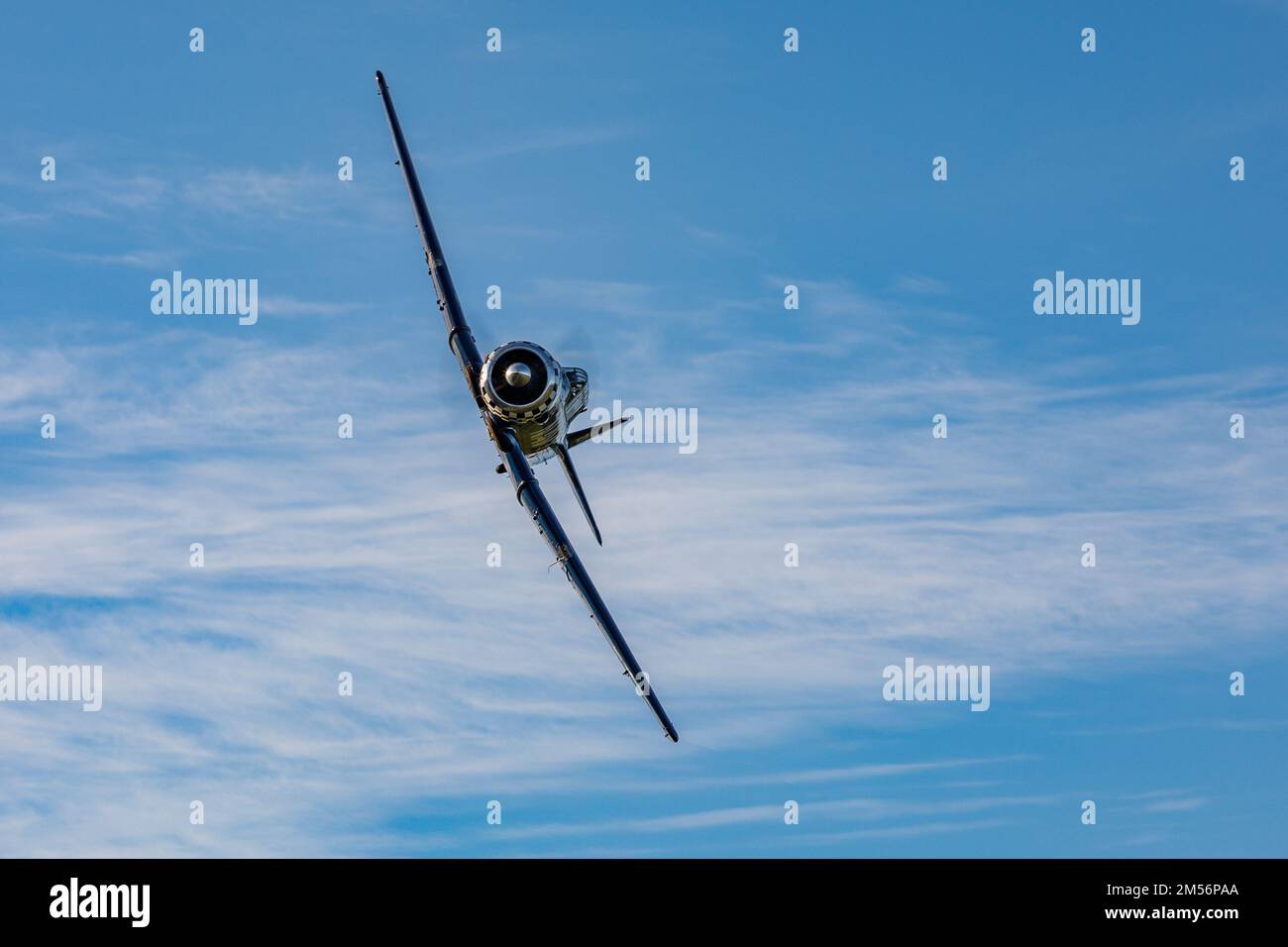 A daytime view of an old airplane flying in the blue clean sky Stock ...