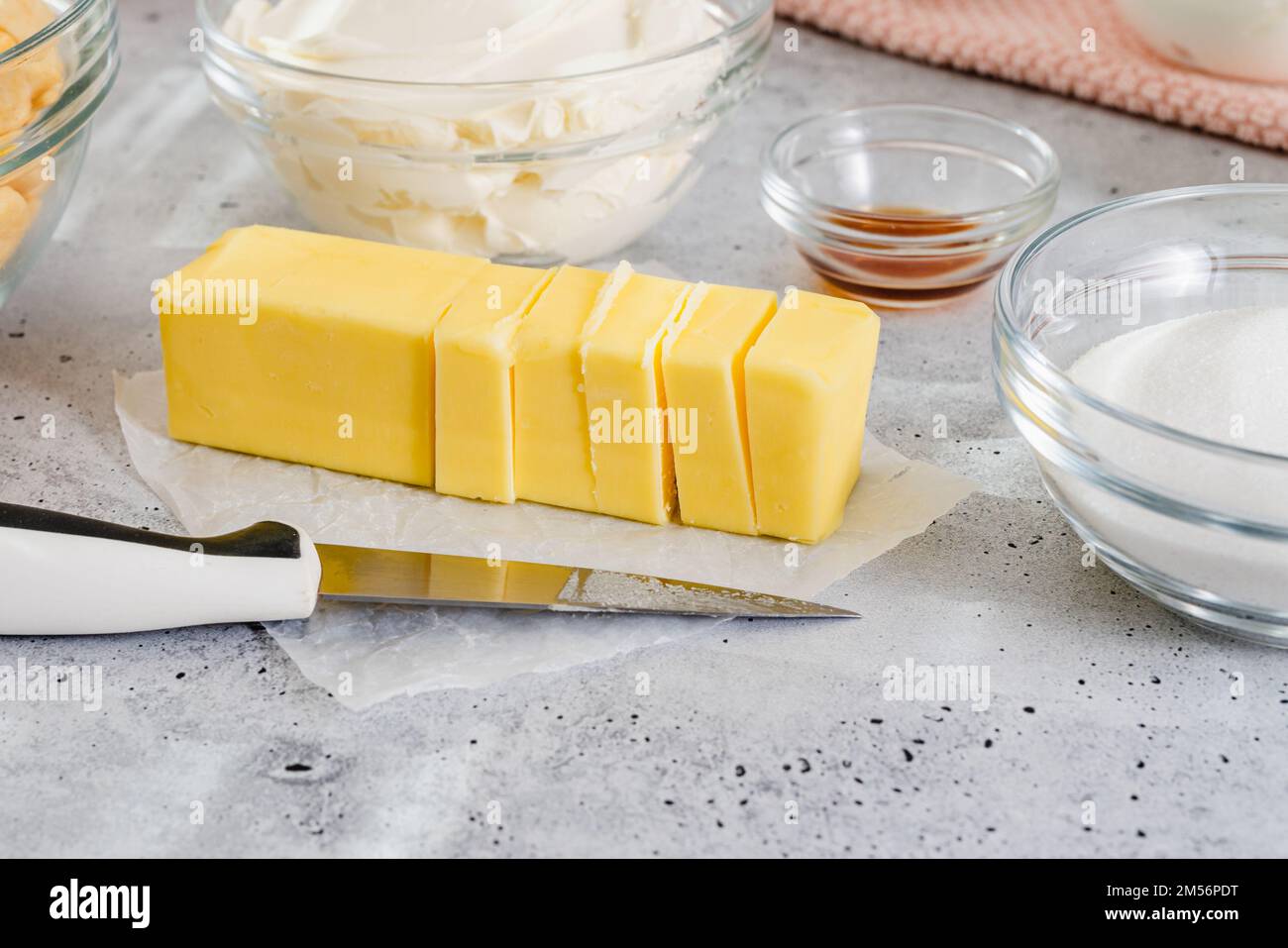 Cut block of butter on the kitchen table. Ingredients for the ...
