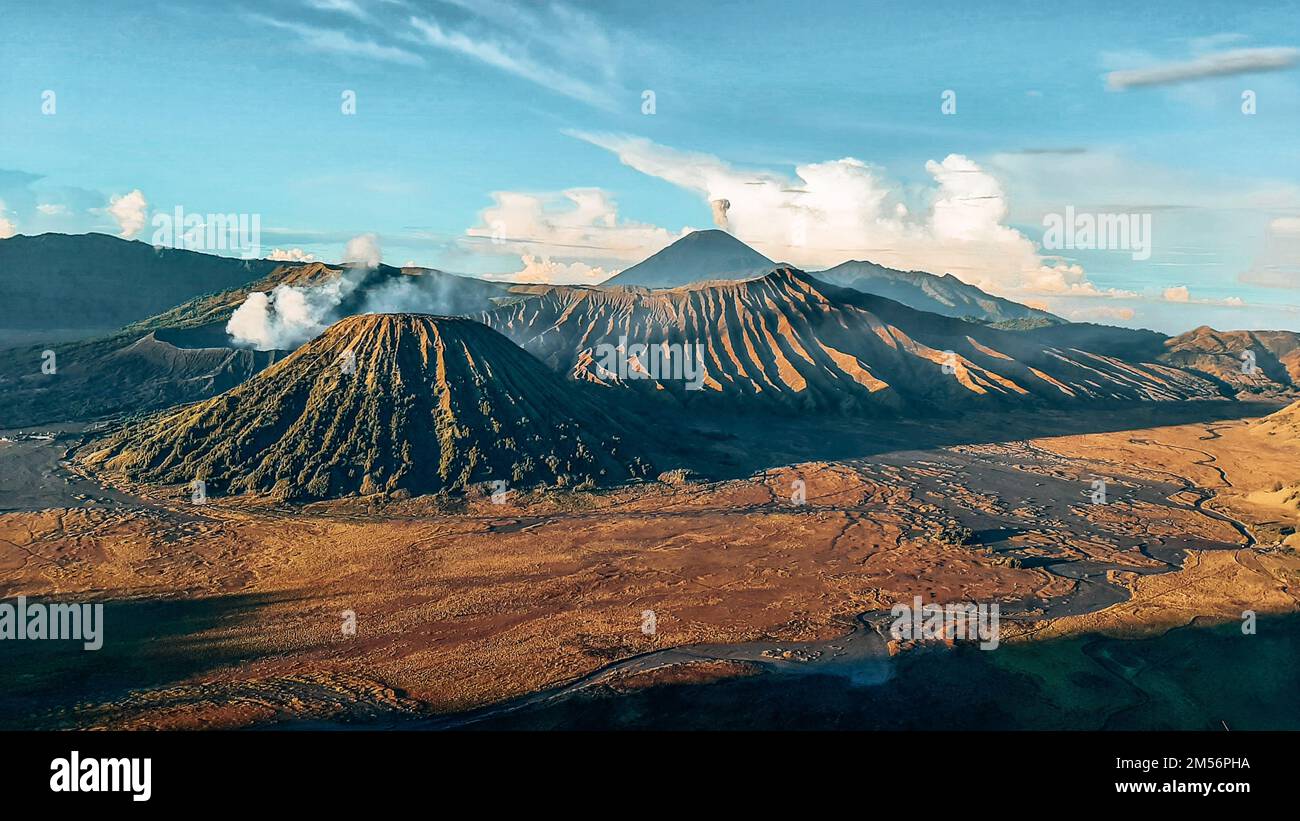 An aerial view of Mount Bromo volcano under blue cloudy sky in ...