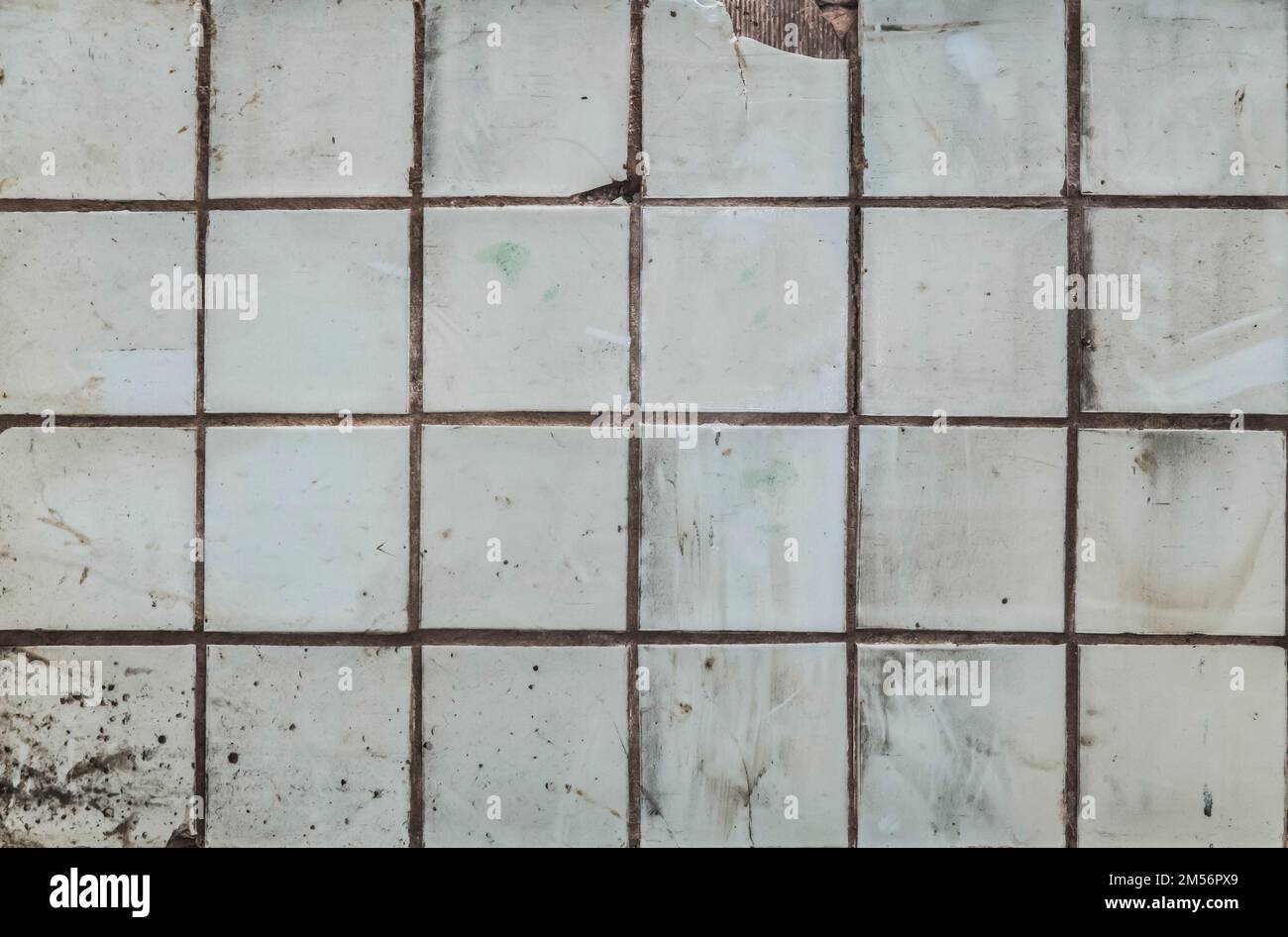 dirty blue tile with chipped edges on the wall Stock Photo - Alamy