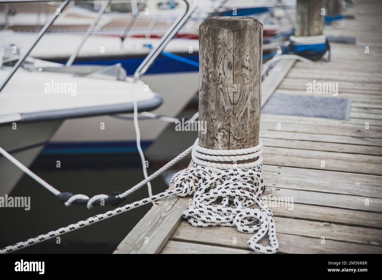 Wooden post for mooring yachts on the pier in Denmark Stock Photo - Alamy