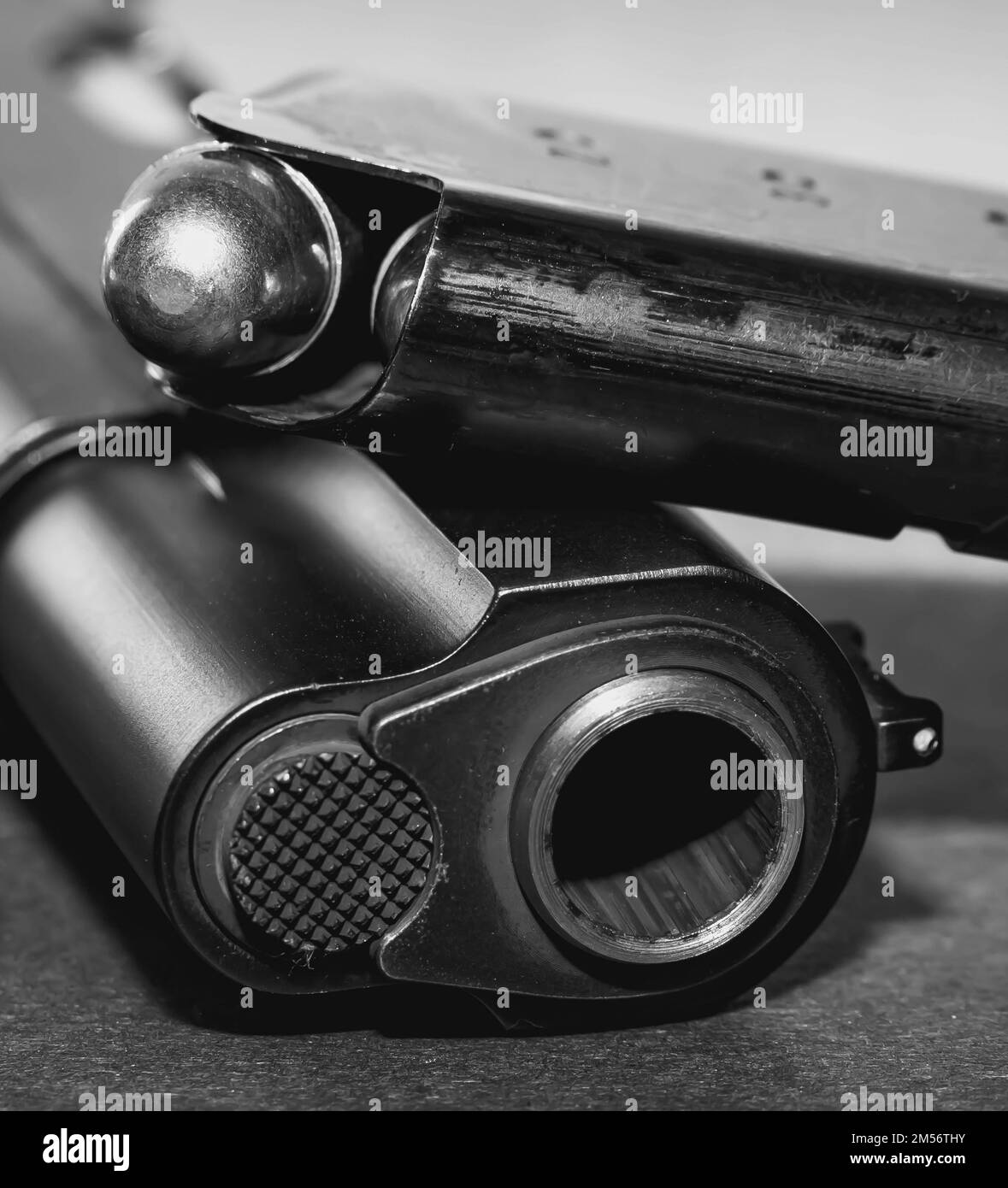 A 45 caliber 1911 model pistol with a loaded magazine on top of it with ...