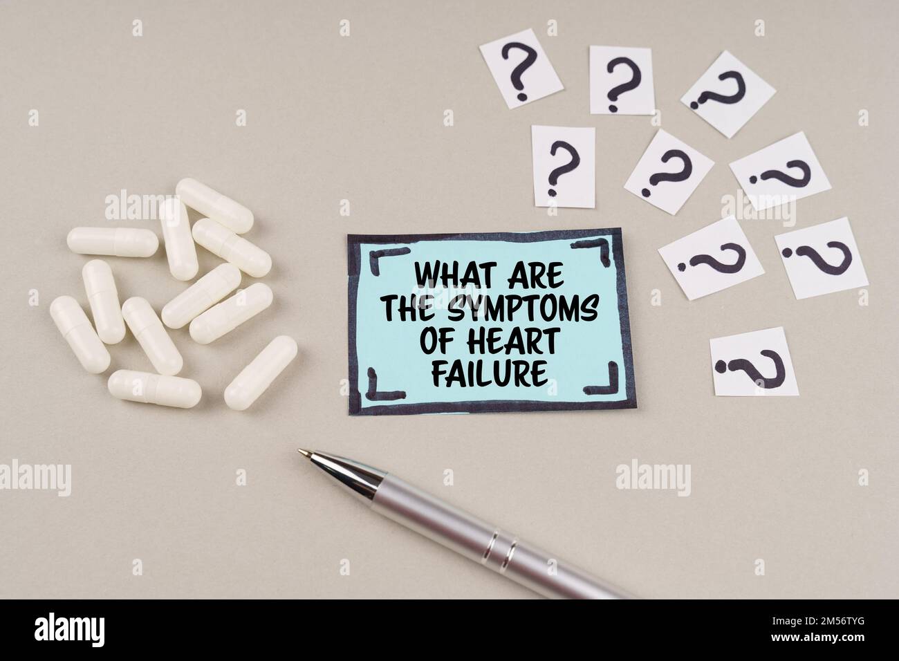 Medical concept. On a gray surface there are question marks and a blue ...