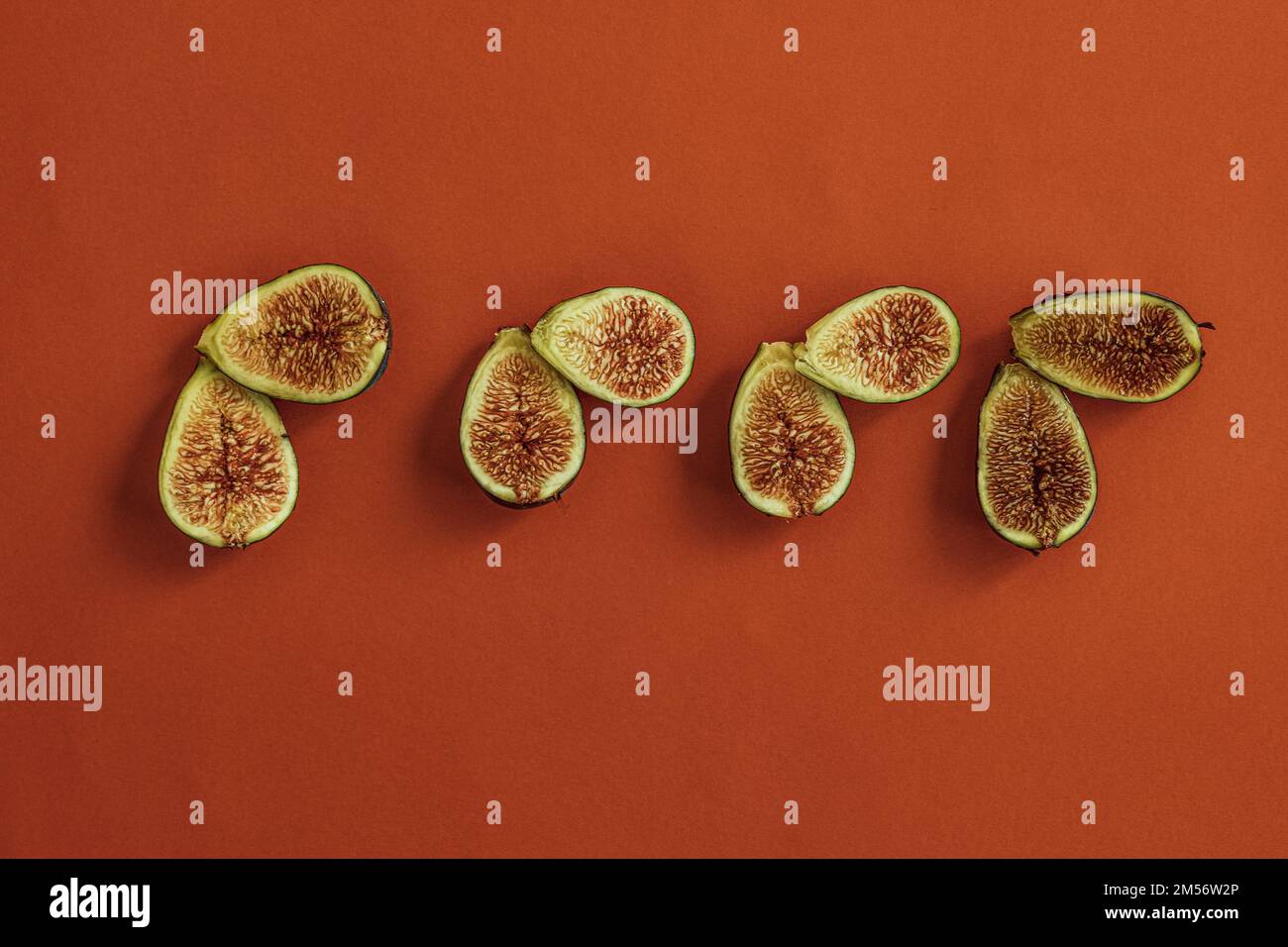 A top view of fig fruits on red background Stock Photo - Alamy
